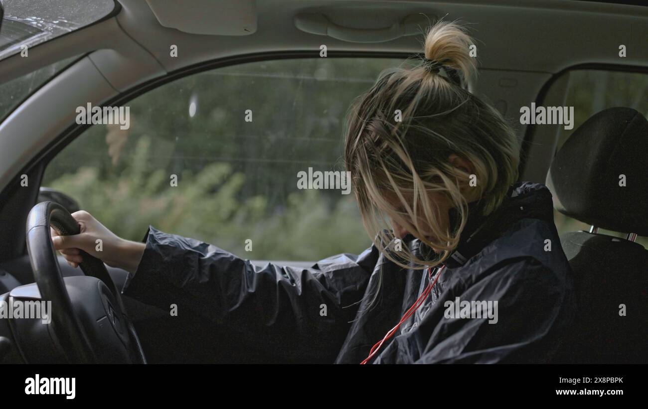 Young man with anxiety driving car. Stock. Close-up of man conveys ...