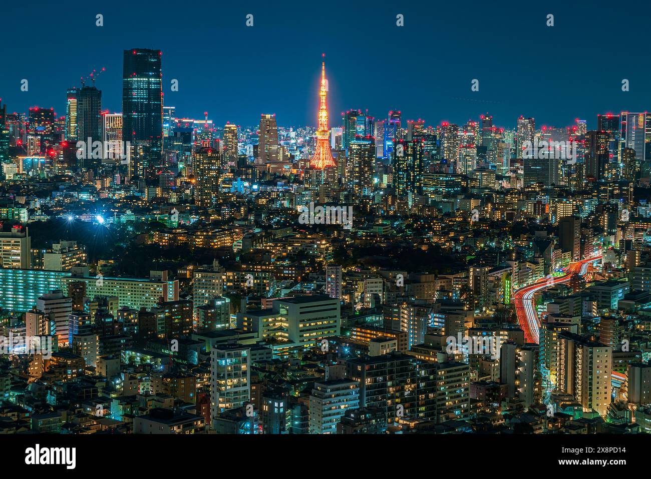 Tokyo Tower illuminates the cityscape, its steel frame contrasting ...