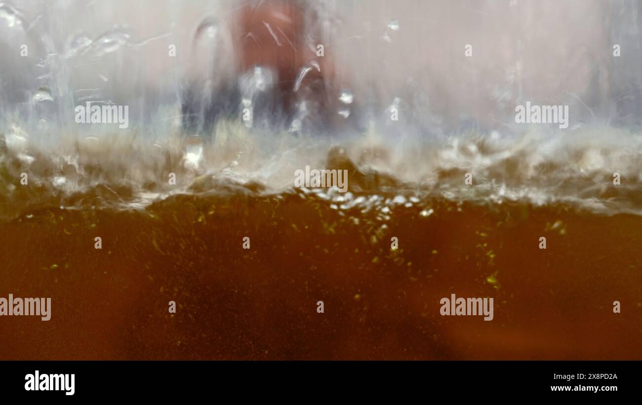 Mechanism spraying liquid substance inside glass container. Media ...