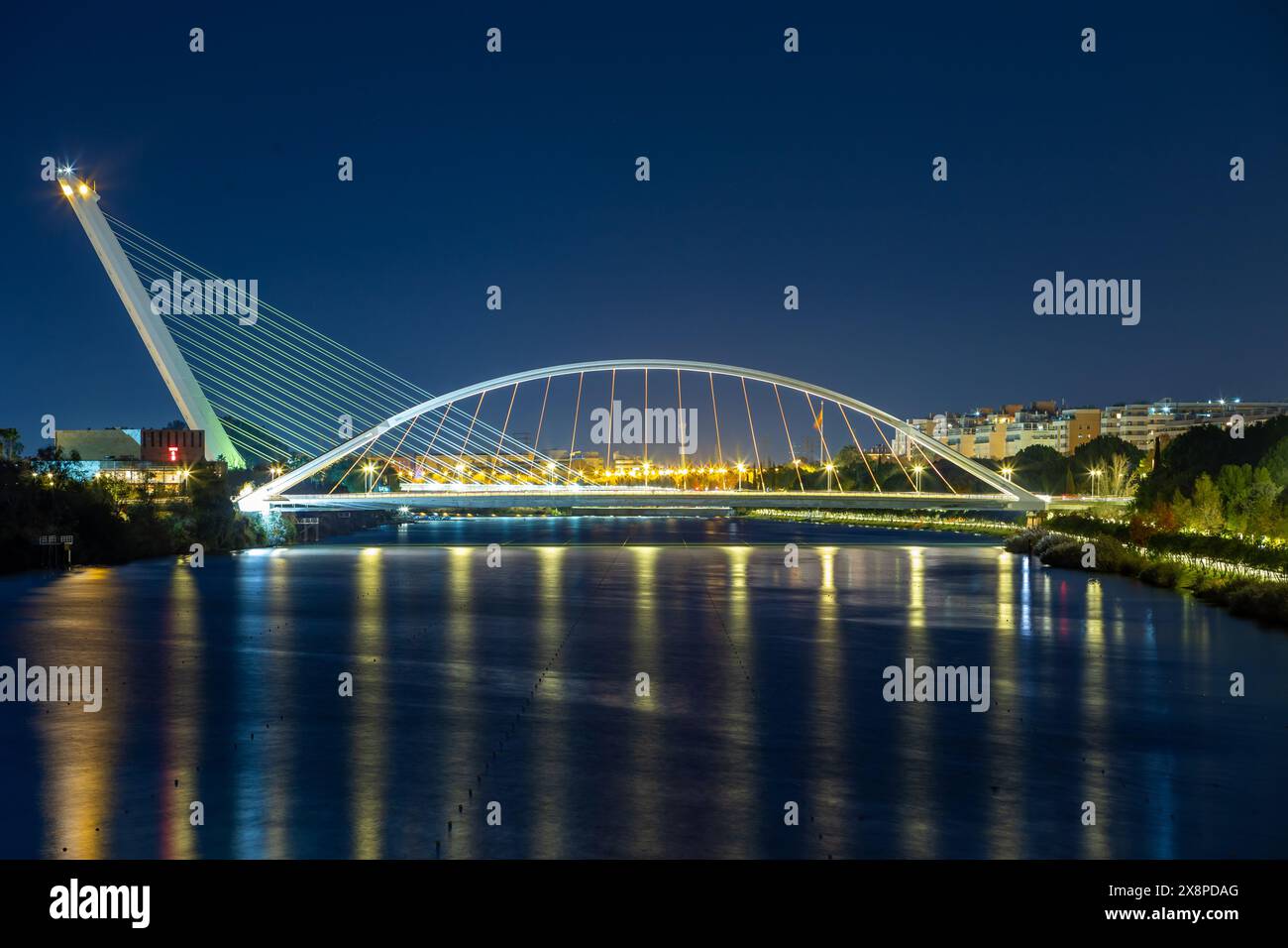 Night view of the Guadalquivir river in Seville with the Barqueta and ...