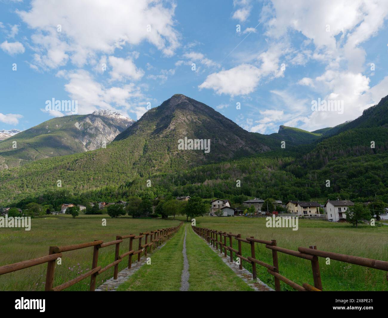 Rural pathway in the town of Fenis with traditional houses and alpine ...