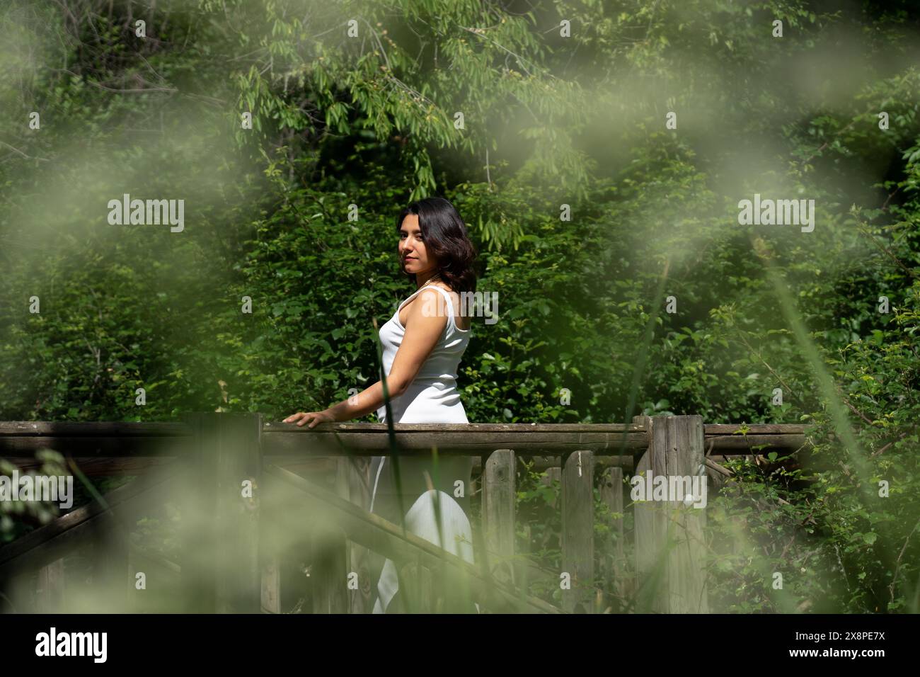 Latin woman taking a walk in nature in a white dress. Mindfulness in ...