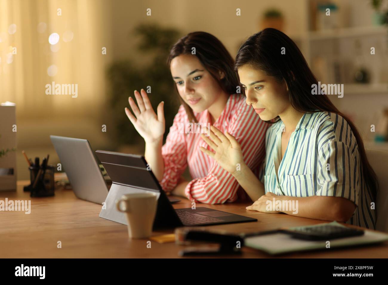 Two tele workers in the night having video call at home Stock Photo - Alamy