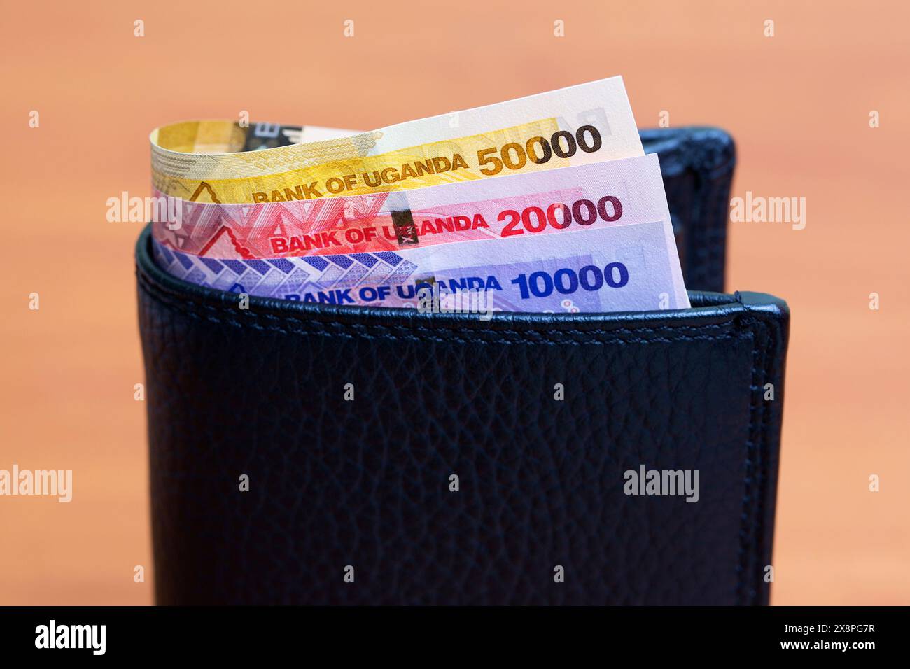 Ugandan money - shilling in the black wallet Stock Photo - Alamy