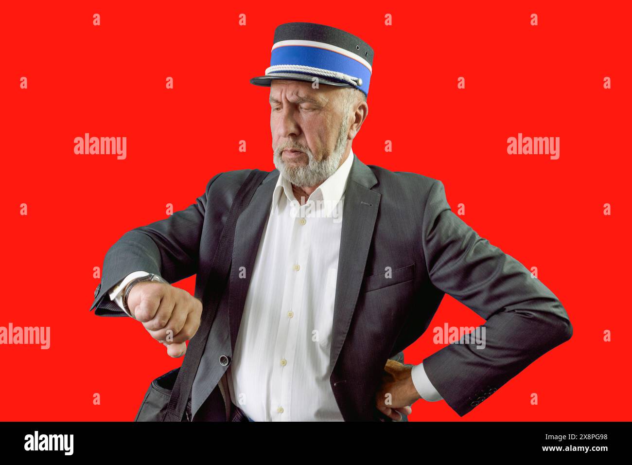 The postman looks at his watch. Red background. Isolated. Portrait of ...