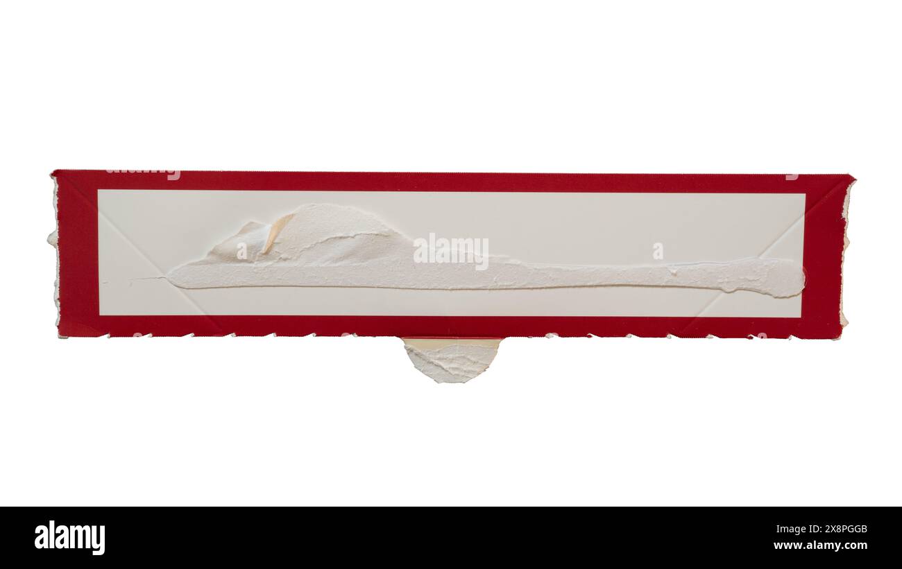 Narrow rectangular white paper with red frame torn from a box packaging ...