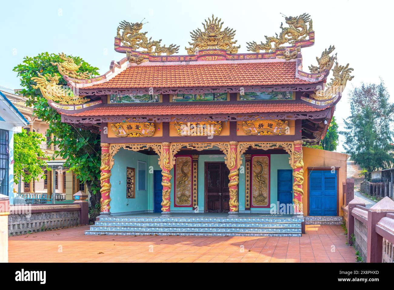 The communal house with elaborate carved columns of pottery is a ...