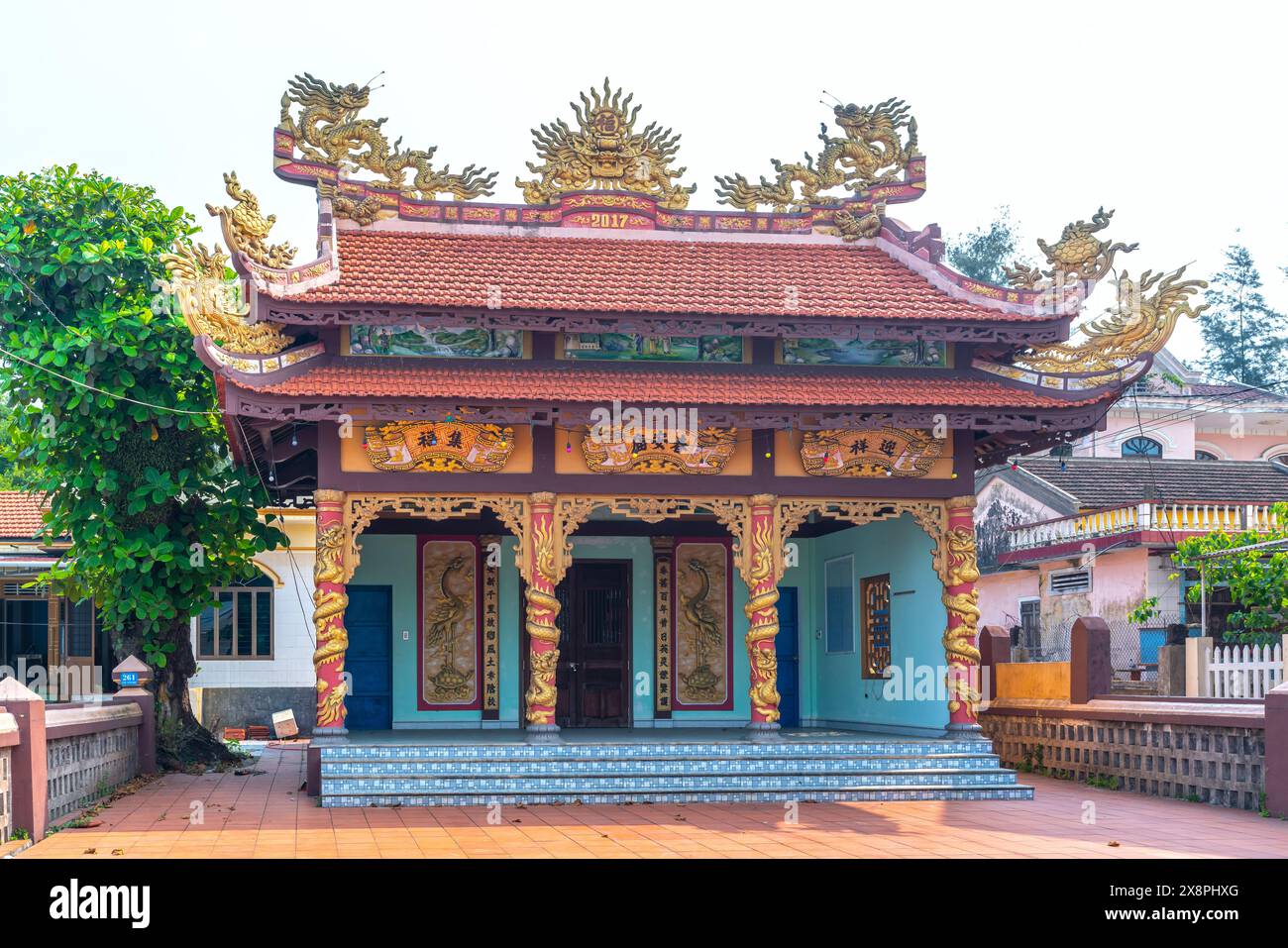 The communal house with elaborate carved columns of pottery is a ...