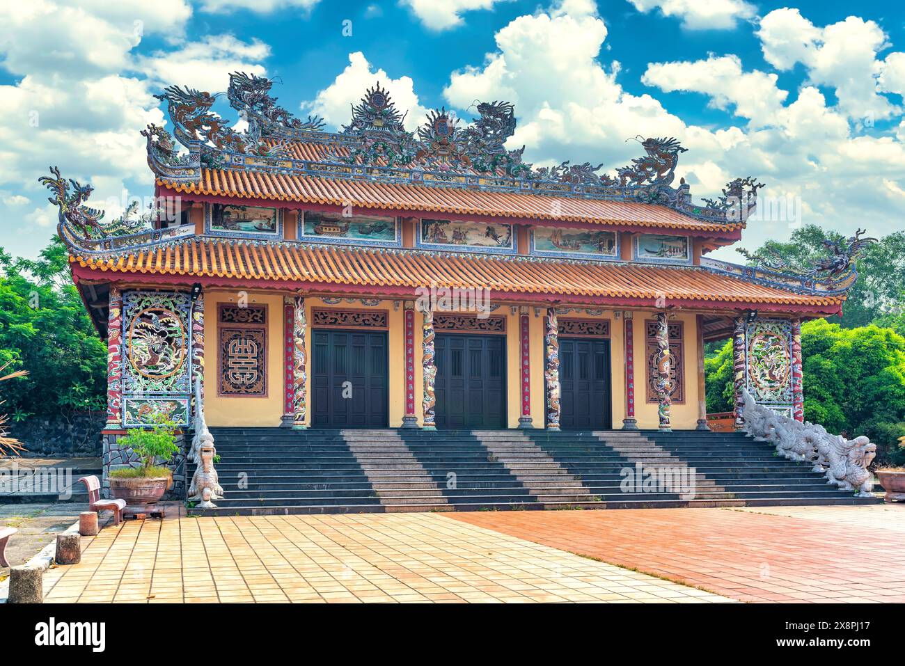 The communal house with elaborate carved columns of pottery is a ...