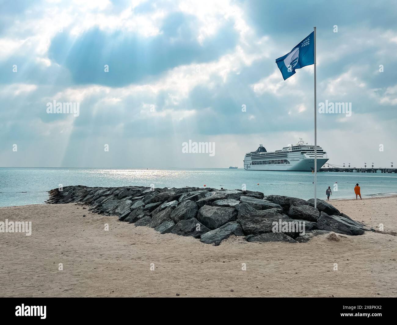 Sir Bani Yas, UAE - January 5, 2024: A tranquil beach scene with a flag ...