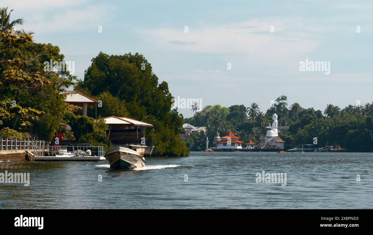 Beautiful river walk with tropical village. Action. River boats ...