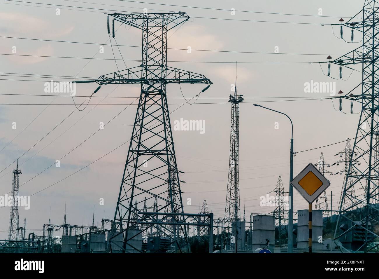 High voltage electric distribution network at sunset. Power ...