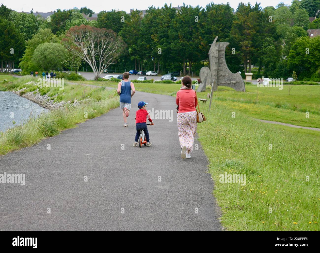 People exercising at the lakeside, Ferte-Mace, Normandie, North West ...