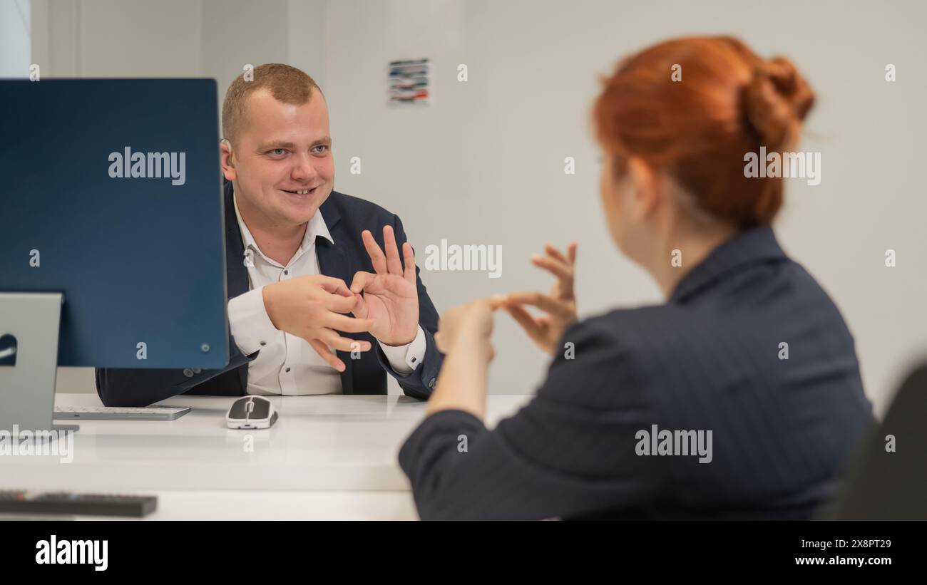 Business partners communicate in sign language. A deaf boss gives a ...