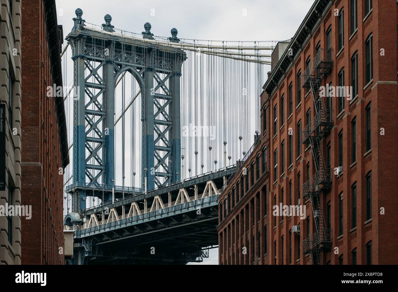 Scenic view of Manhattan Bridge between buildings in New York City ...