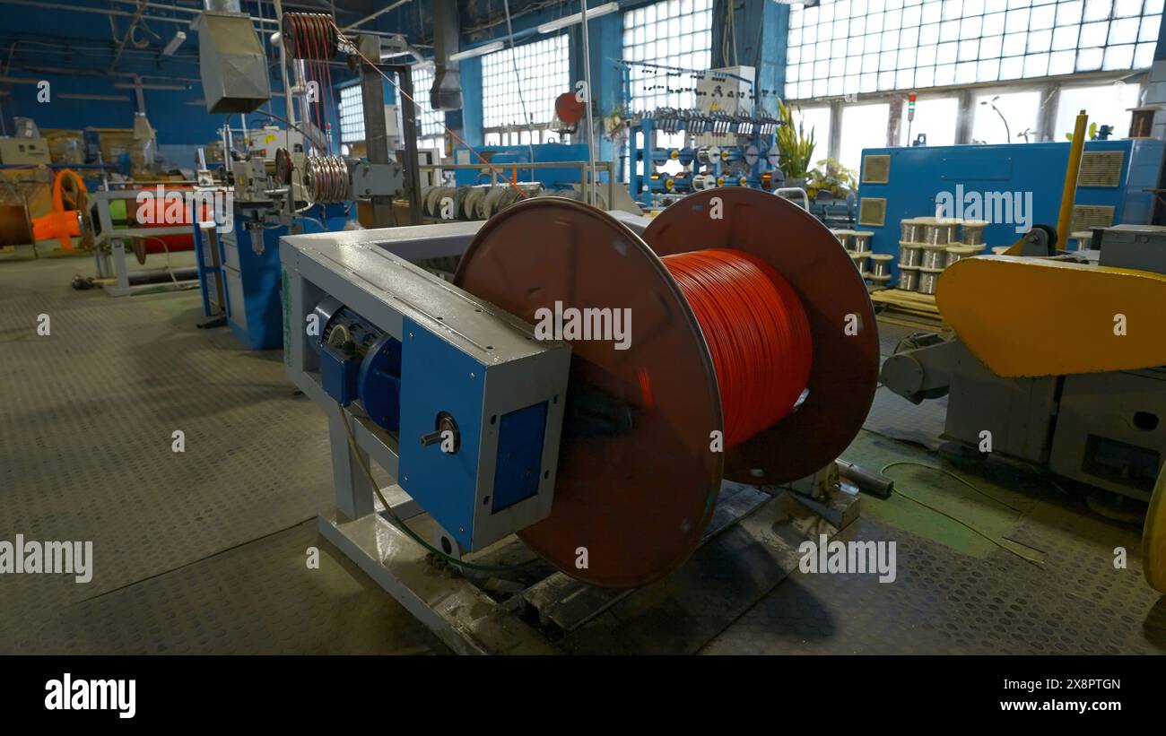 Rotating coil with wires in factory. Creative. Winding cable on to coil ...