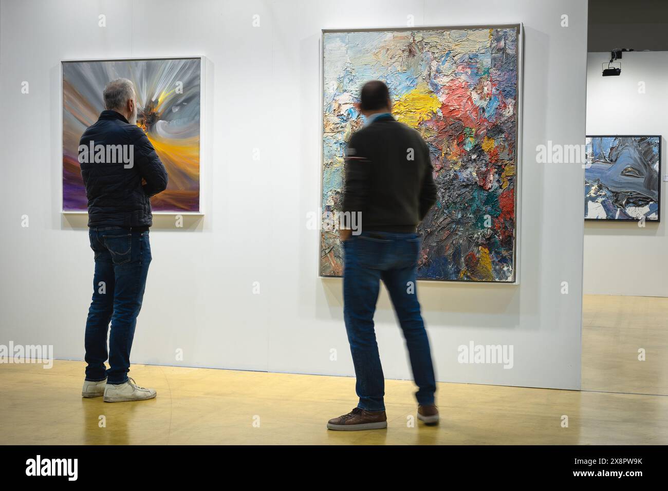 People Walking and Admiring Paintings in a Modern Art Gallery Stock ...