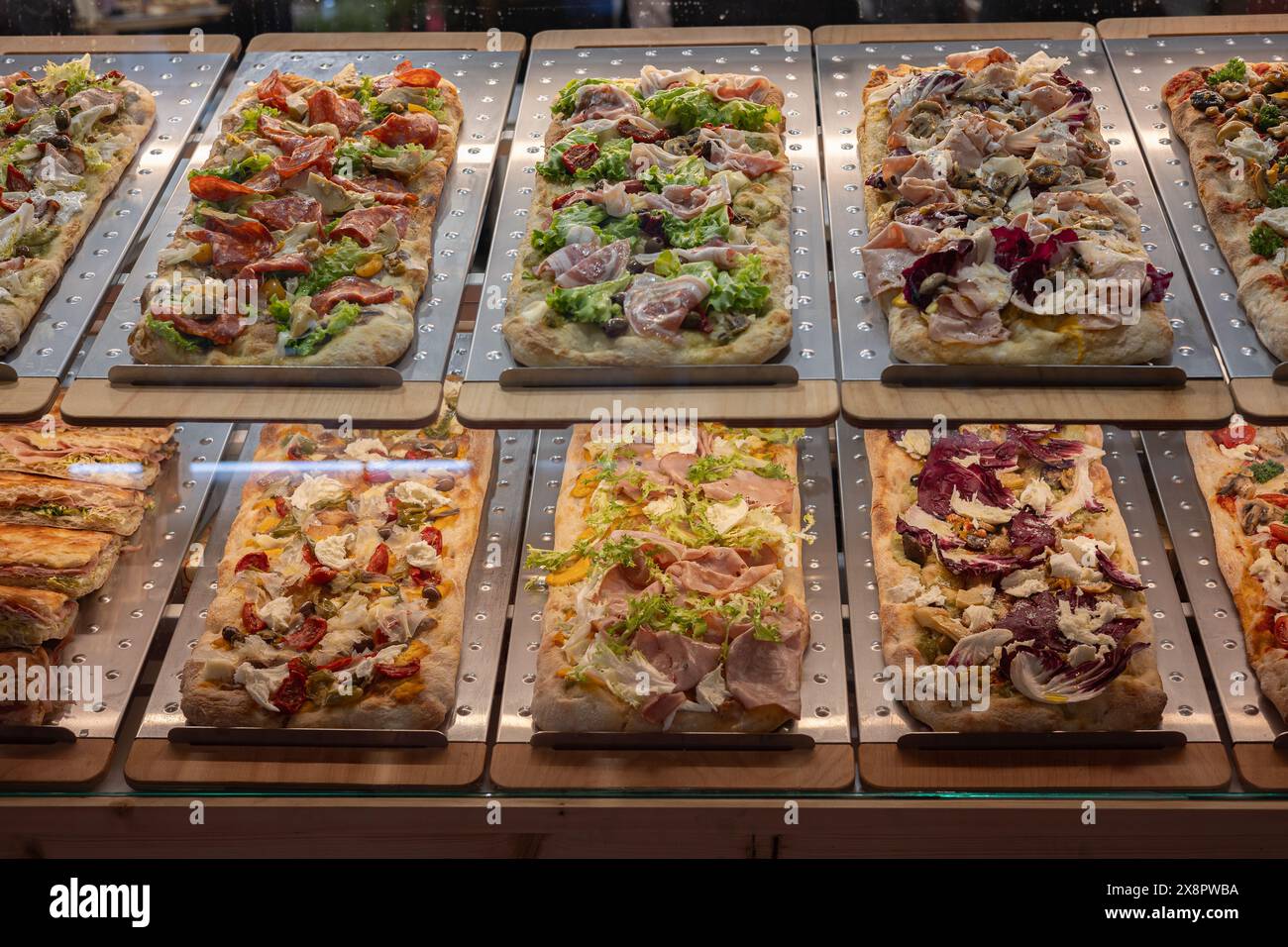 Two Racks of Freshly Baked Pizzas with various Toppings Stock Photo - Alamy