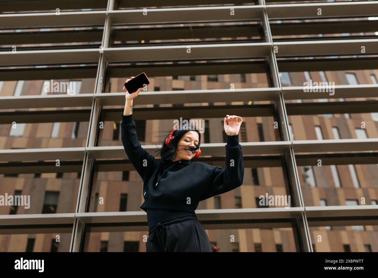 Woman dancing joyfully against vibrant hi-res stock photography and ...