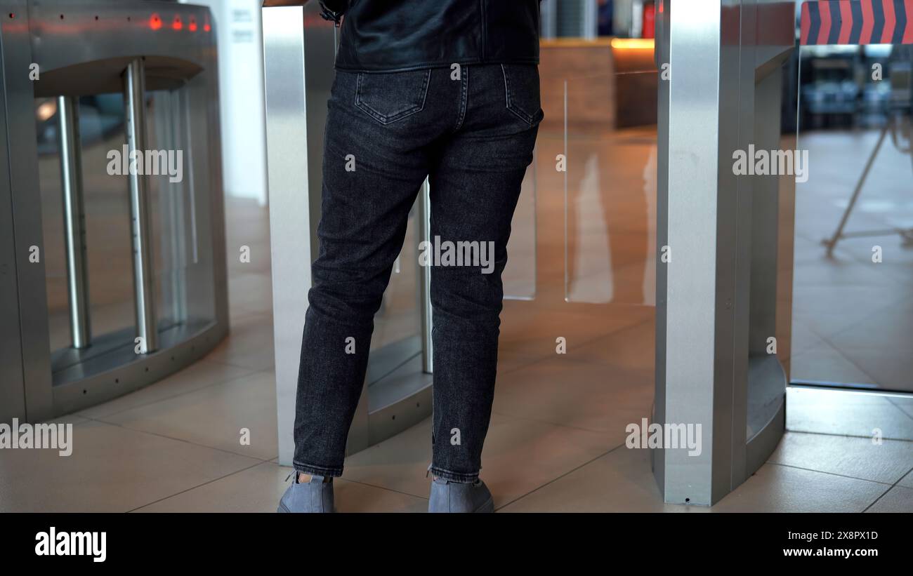 Passengers pass through automatic turnstiles at the metro station ...