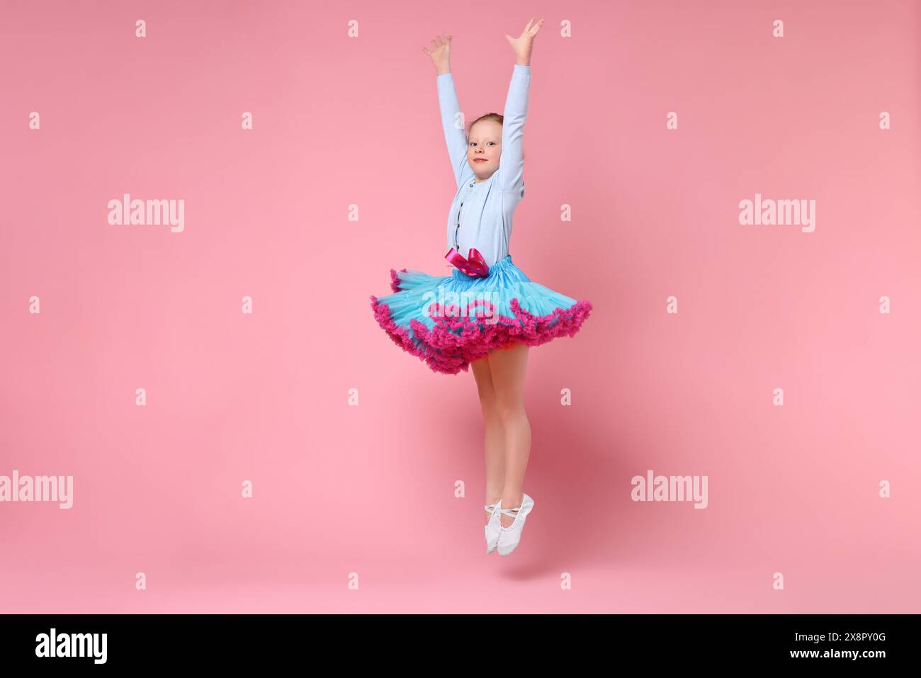 Cute little girl dancing on pink background Stock Photo - Alamy