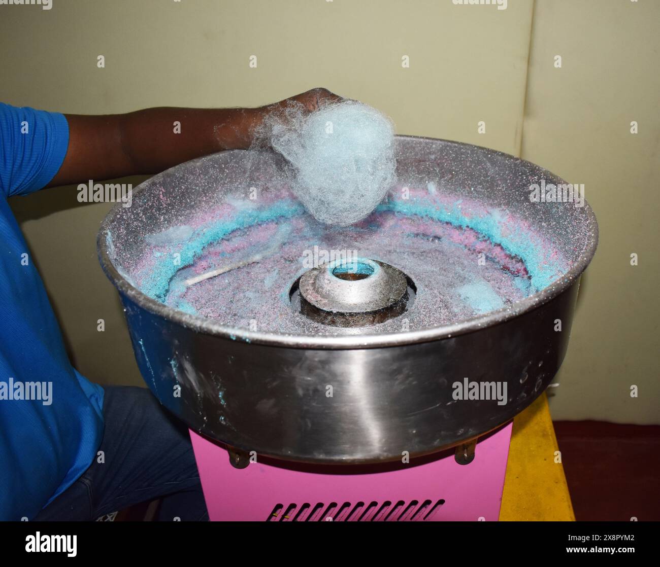 A man making candy floss. Cotton candy, also known as candy floss and ...