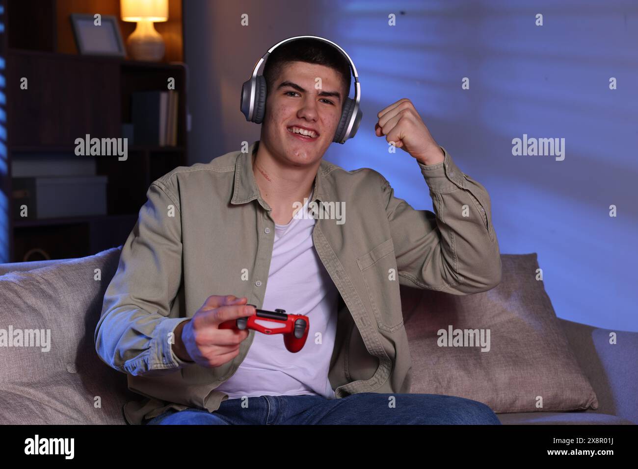 Emotional man playing video games with controller at home Stock Photo ...