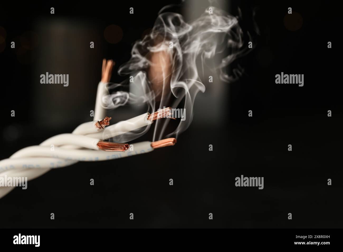 Wiring with smoke on dark background, closeup Stock Photo - Alamy