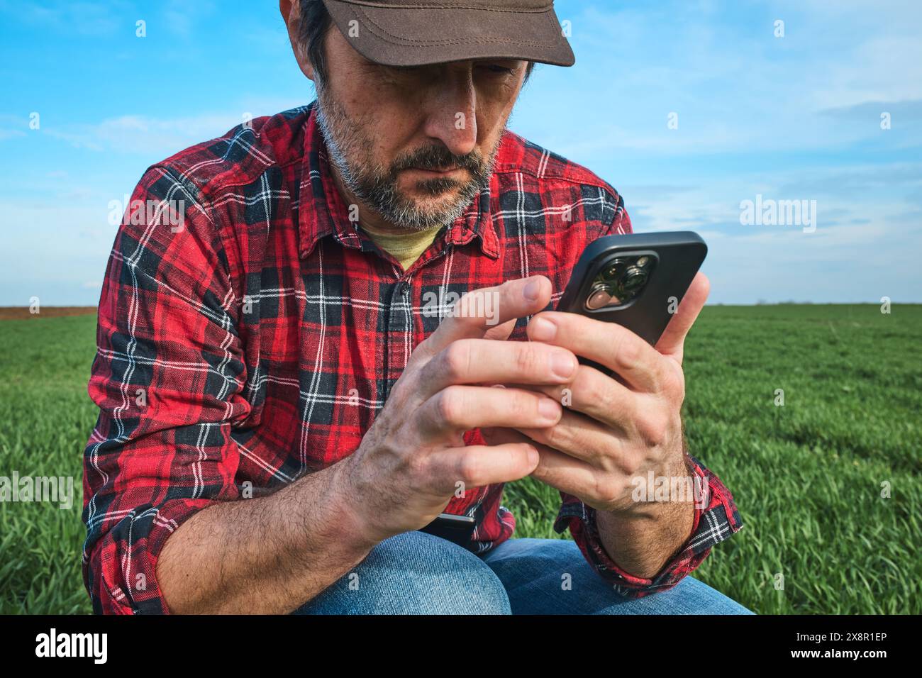 Farmer using smartphone app in modern smart farming concept, selective ...