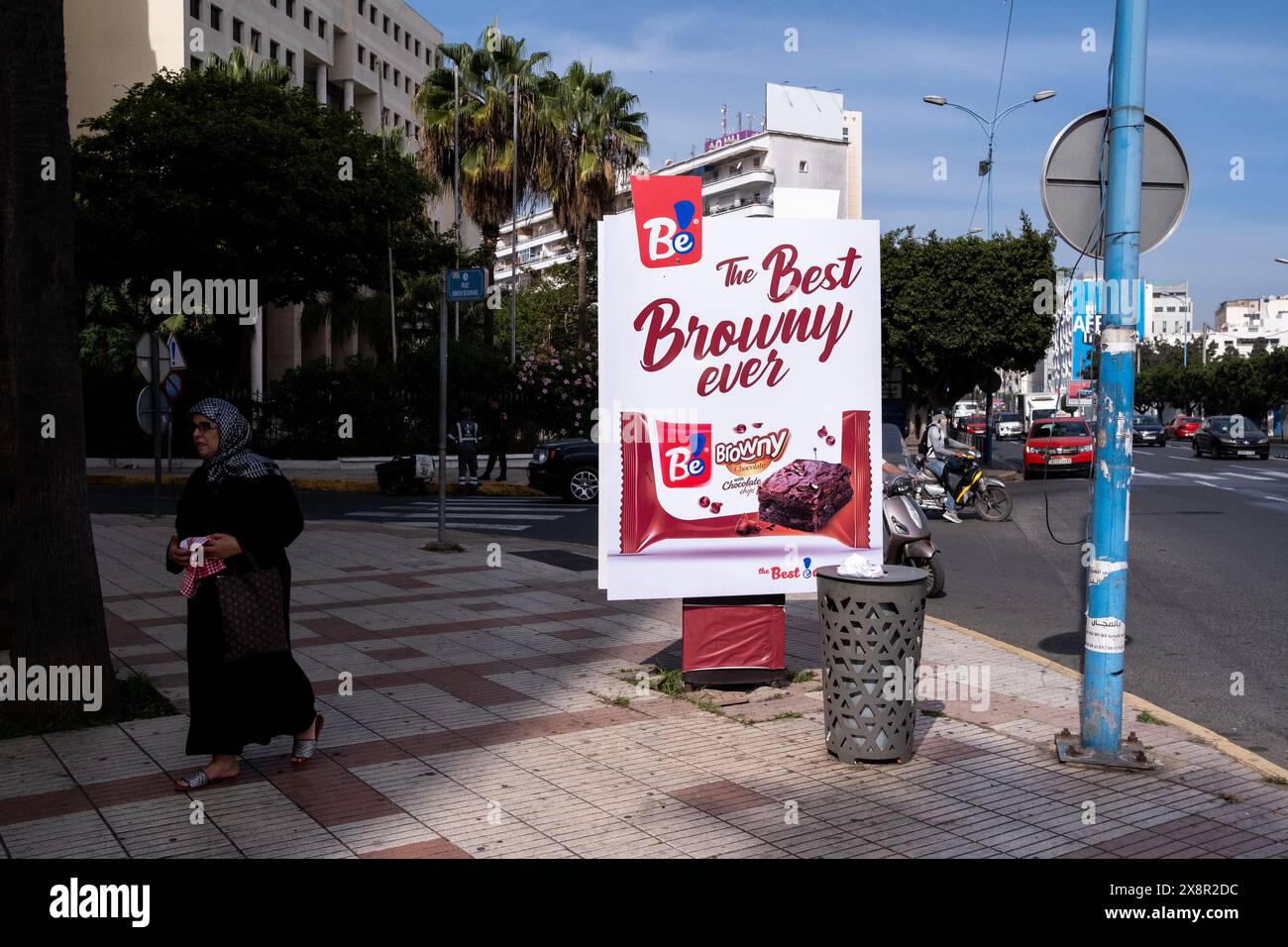 A woman walking past a billboard advertising "the best Browny ever" in ...