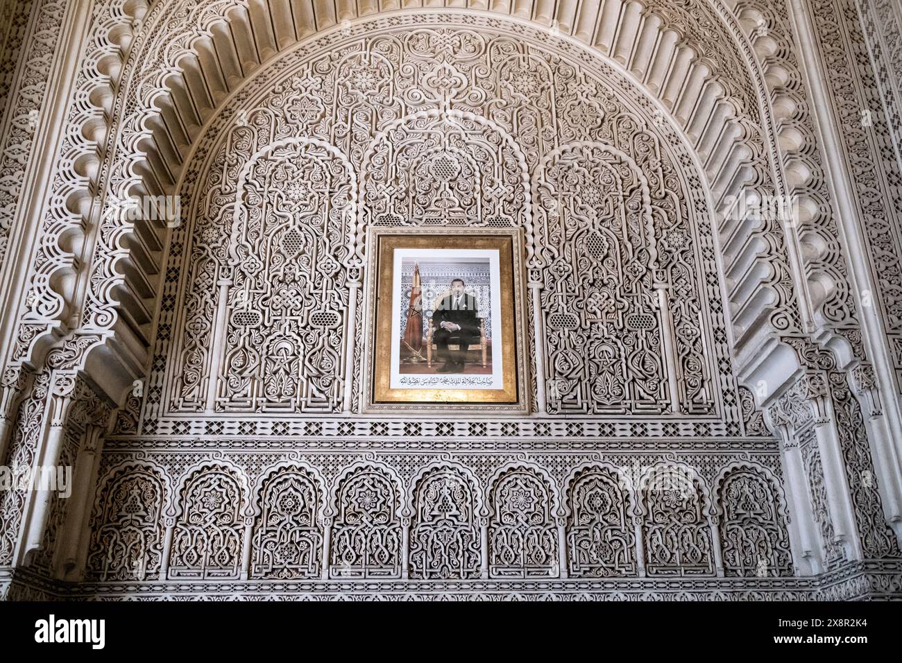 A portrait of King Mohammed VI with Moroccan flags at the Mahkama of ...