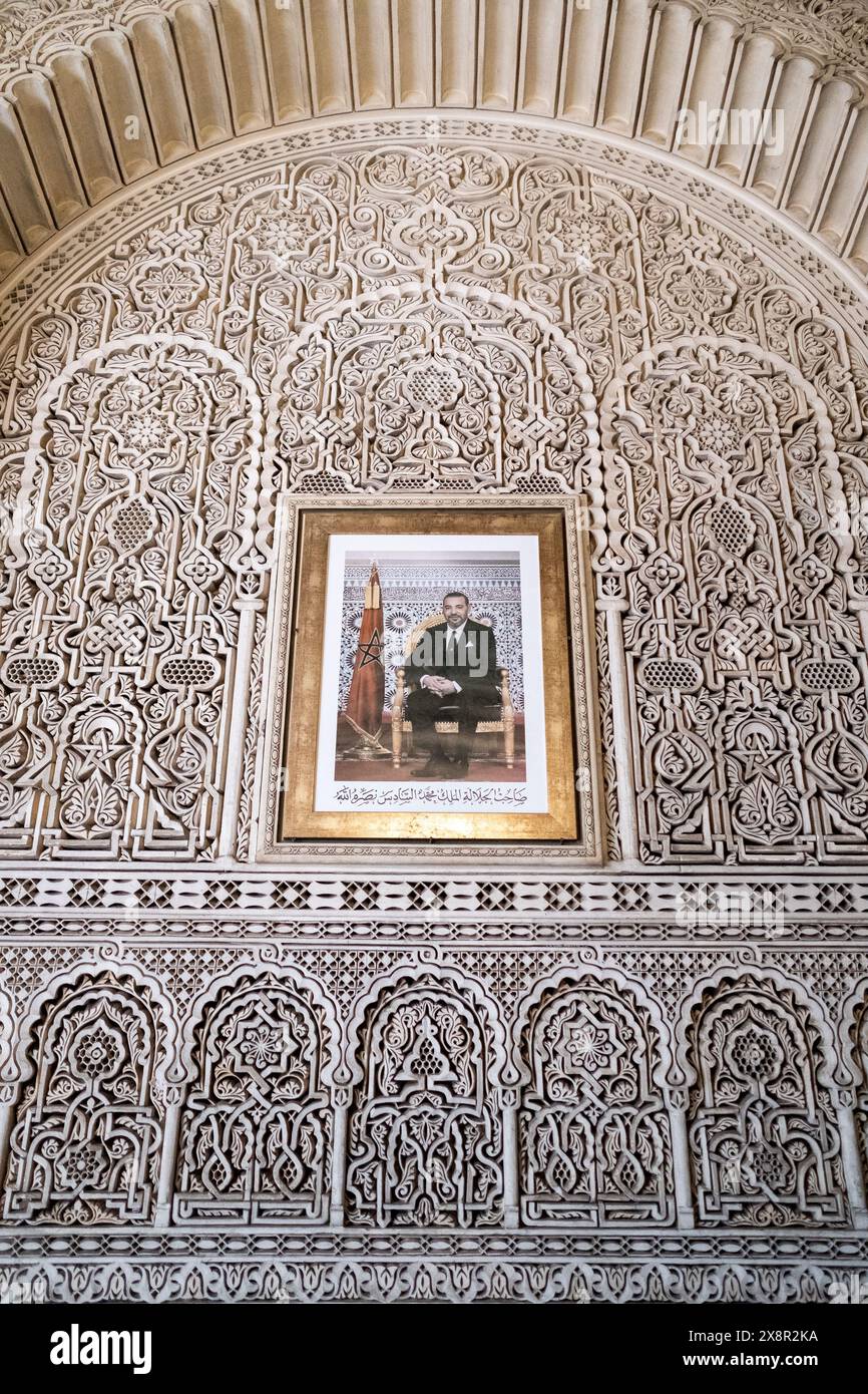A portrait of King Mohammed VI with Moroccan flags at the Mahkama of ...