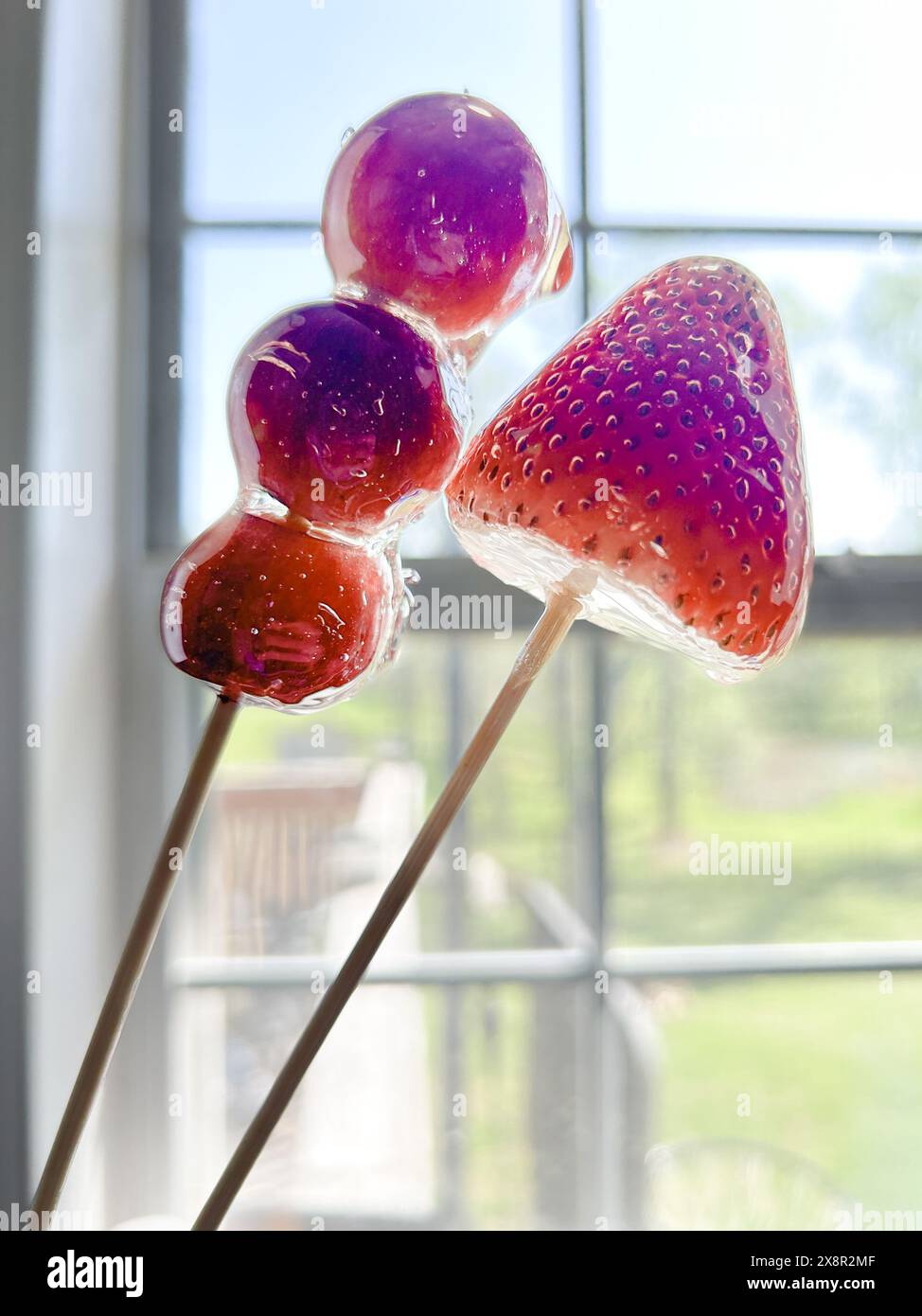 Candied strawberries and grapes on skewers by kitchen window Stock ...
