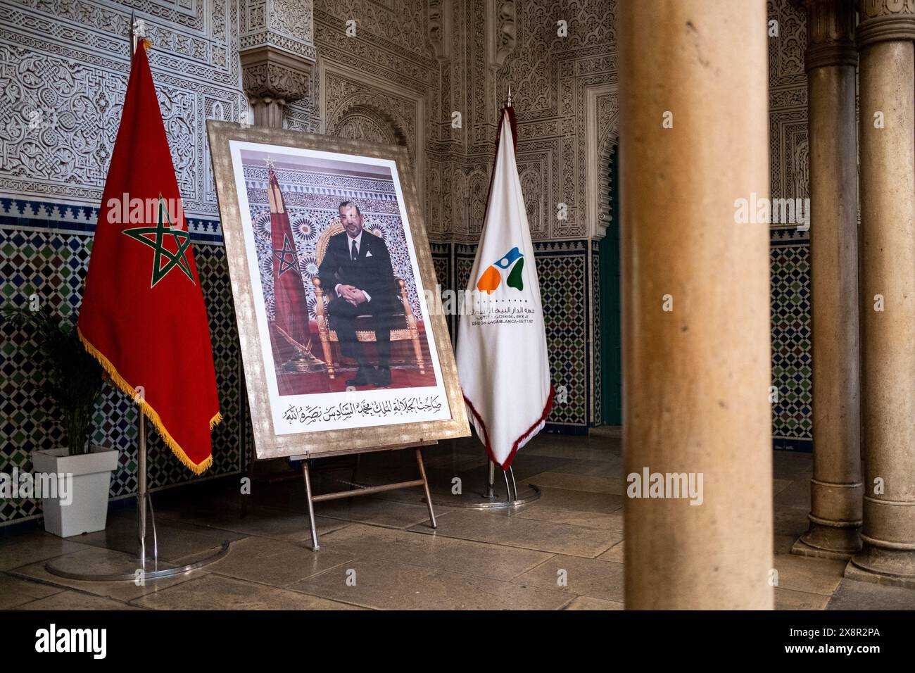 A portrait of King Mohammed VI with Moroccan flags at the Mahkama of ...