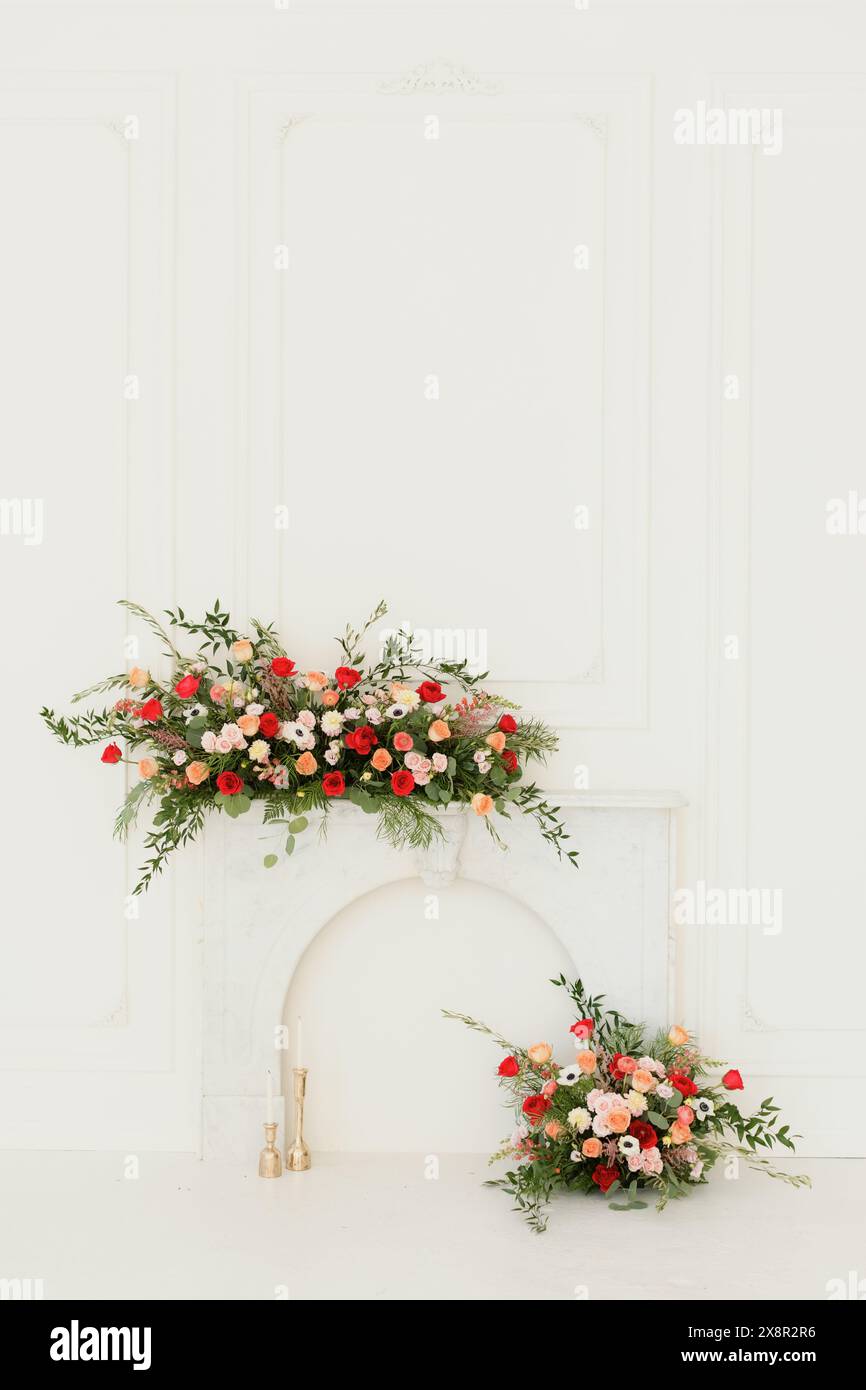 Elegant florals on a white mantle with roses and greenery Stock Photo ...