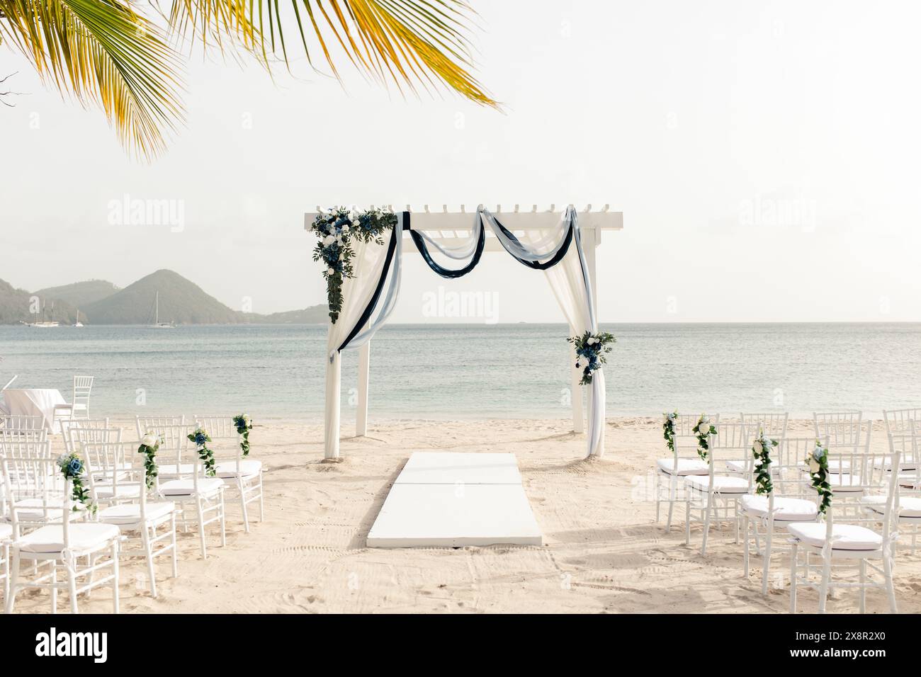 Beach wedding setup in St. Lucia with floral arch and ocean view Stock ...