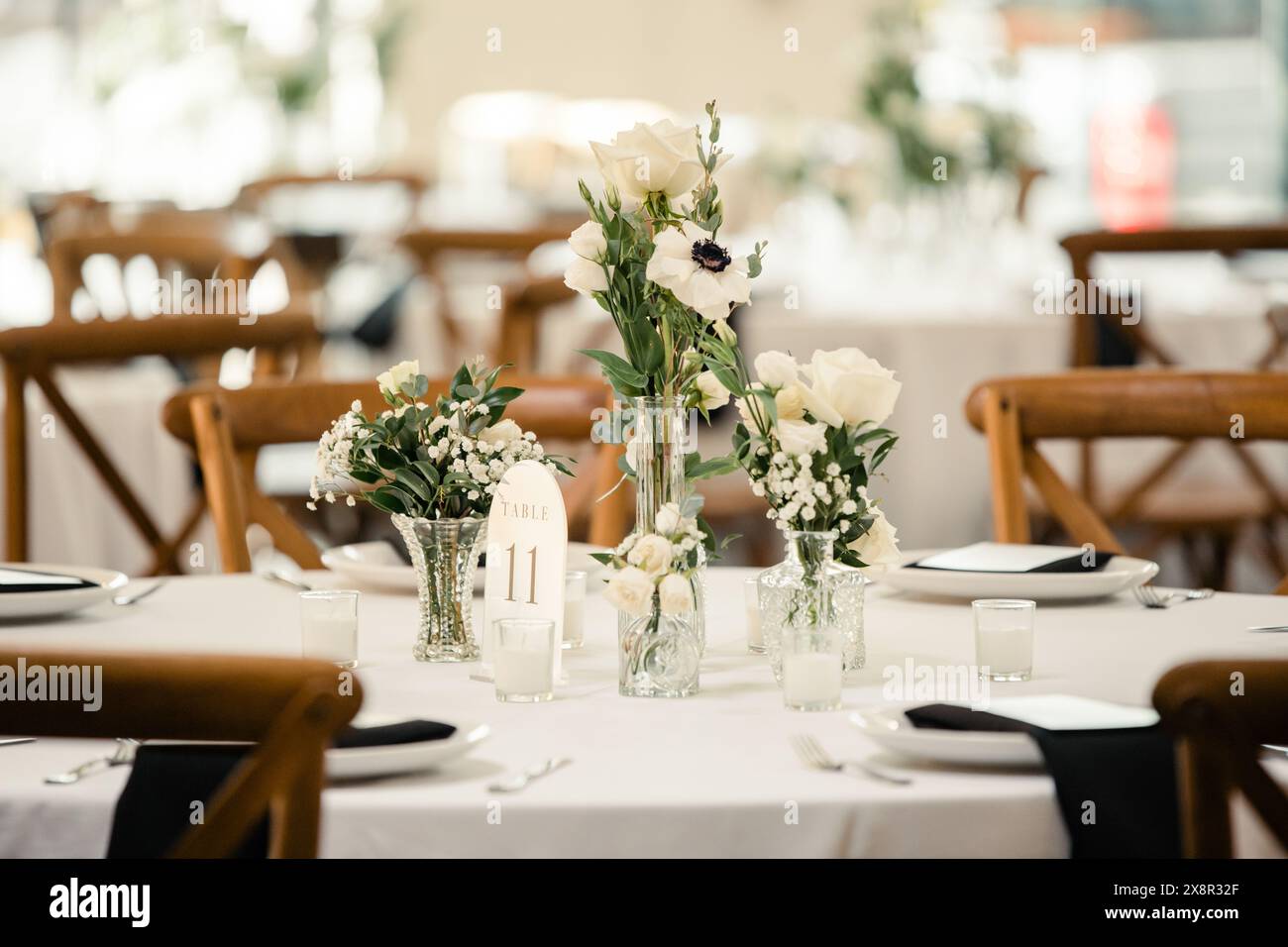 wedding reception table with white floral decor Stock Photo - Alamy
