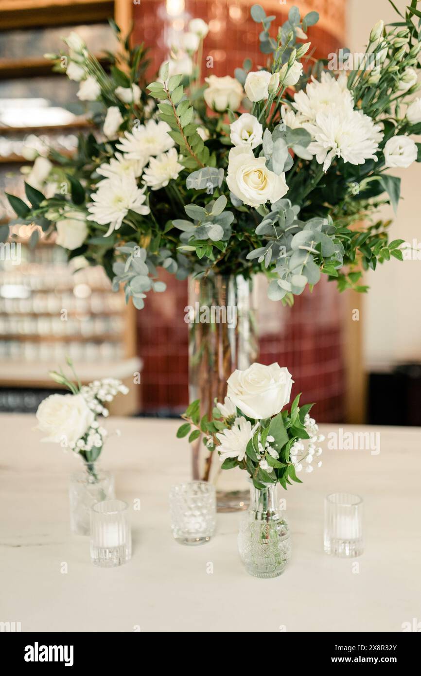 White floral arrangements on elegant bar setting Stock Photo - Alamy