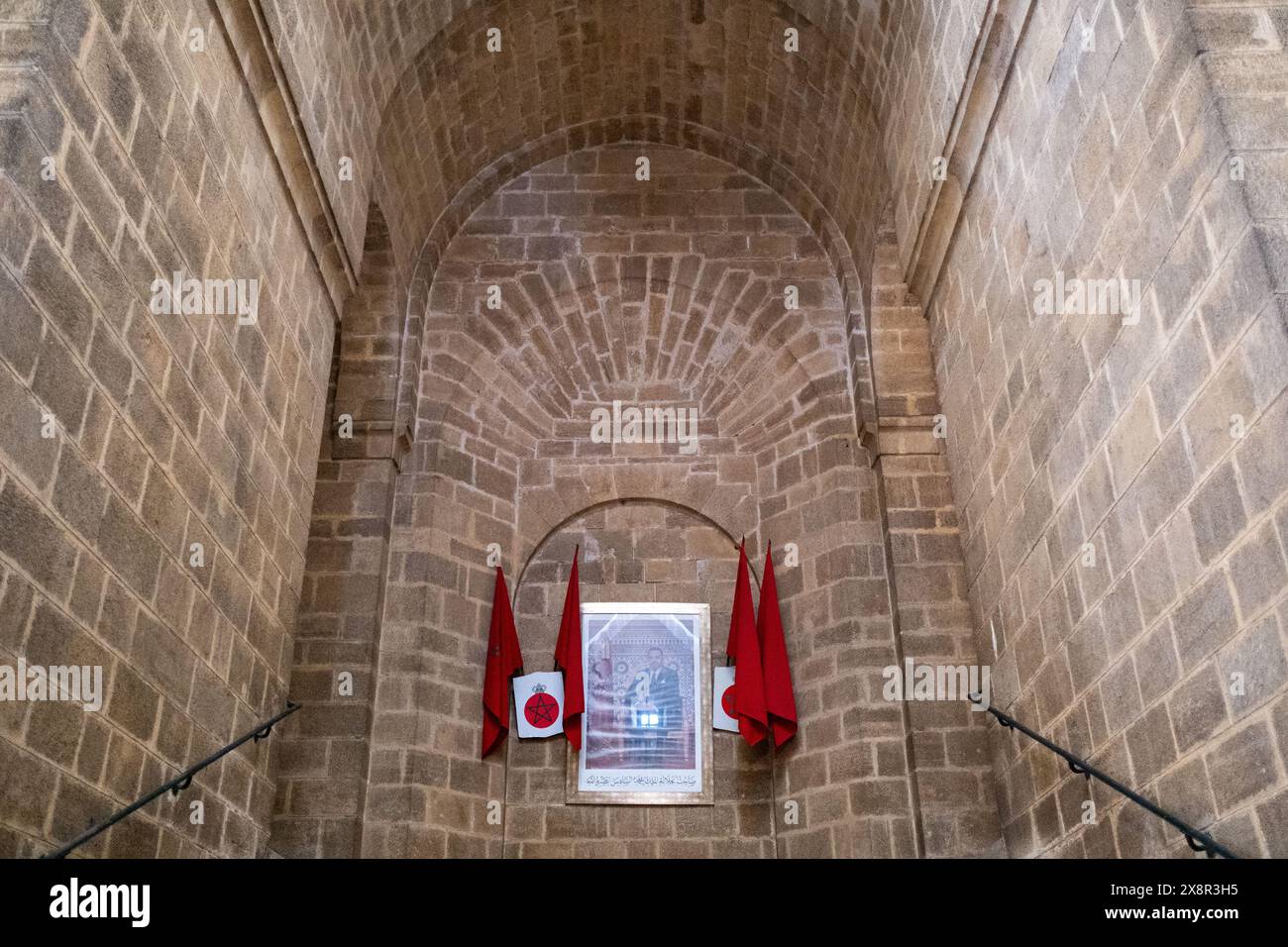 A portrait of King Mohammed VI with Moroccan flags at the Mahkama of ...