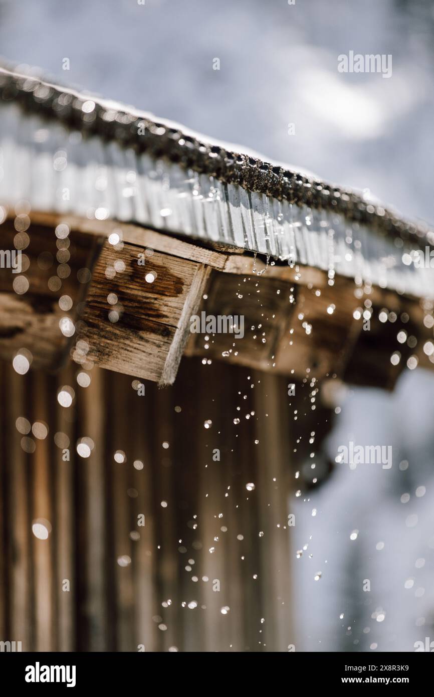 Melting snow dripping from a roof in KitzbÃ¼hel ski area Stock Photo ...