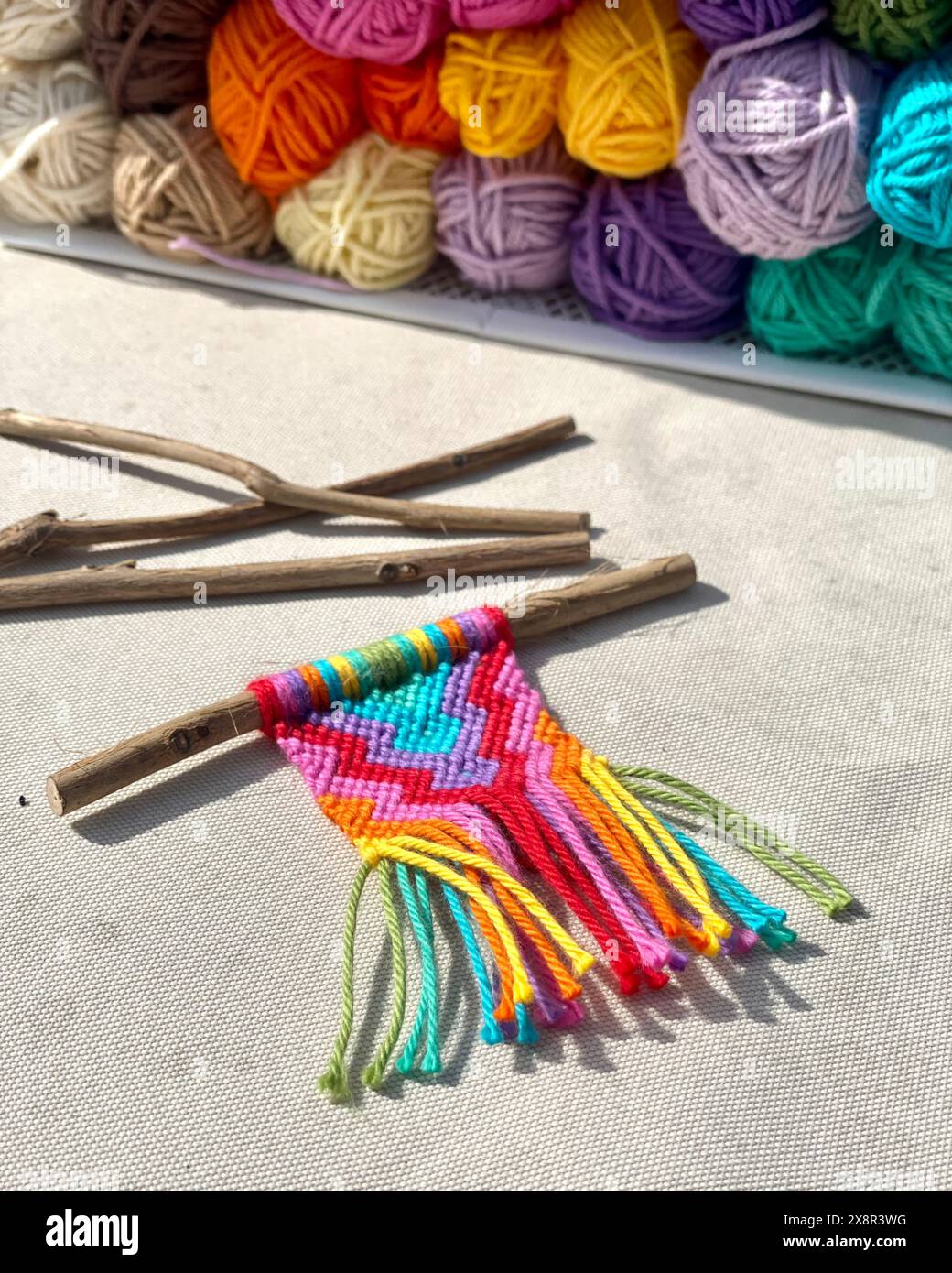Colorful Thread Skeins and a Mini Macrame Wall Hanging Stock Photo - Alamy