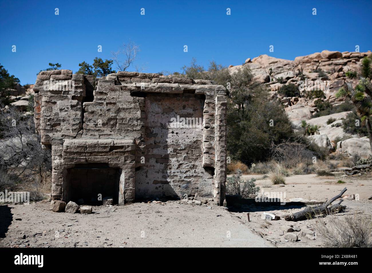 Ruined stone structure in desert landscape with rocky backdrop Stock ...