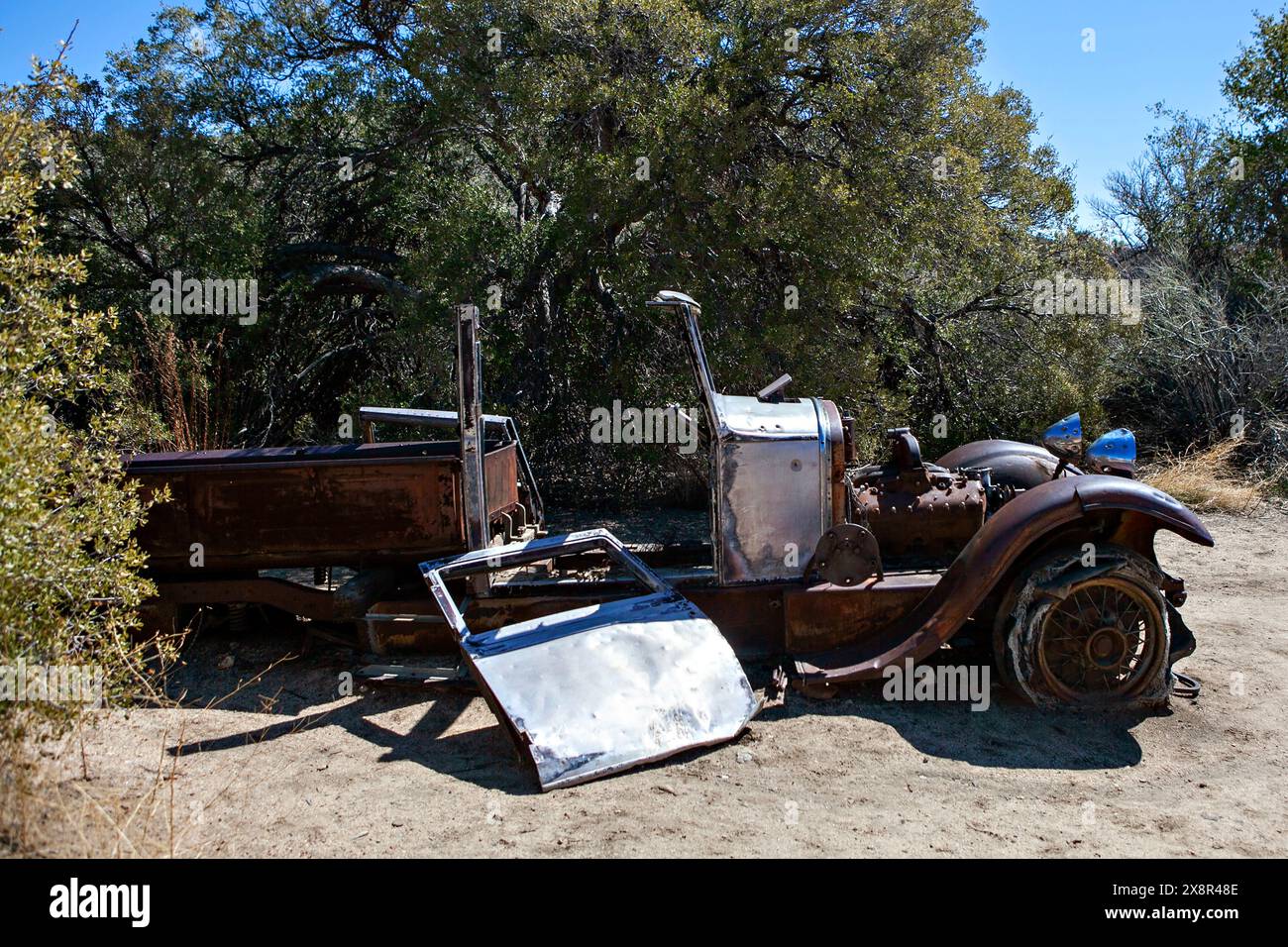 Abandoned vintage car wreck in a desert woodland Stock Photo - Alamy
