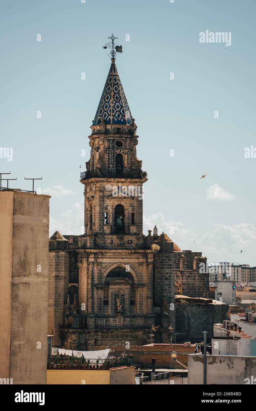Spanish Church Tower With Birds Circling Mid Day Stock Photo - Alamy