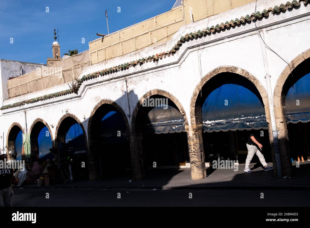 A row of arches with a minaret visible in the background in the Habous ...