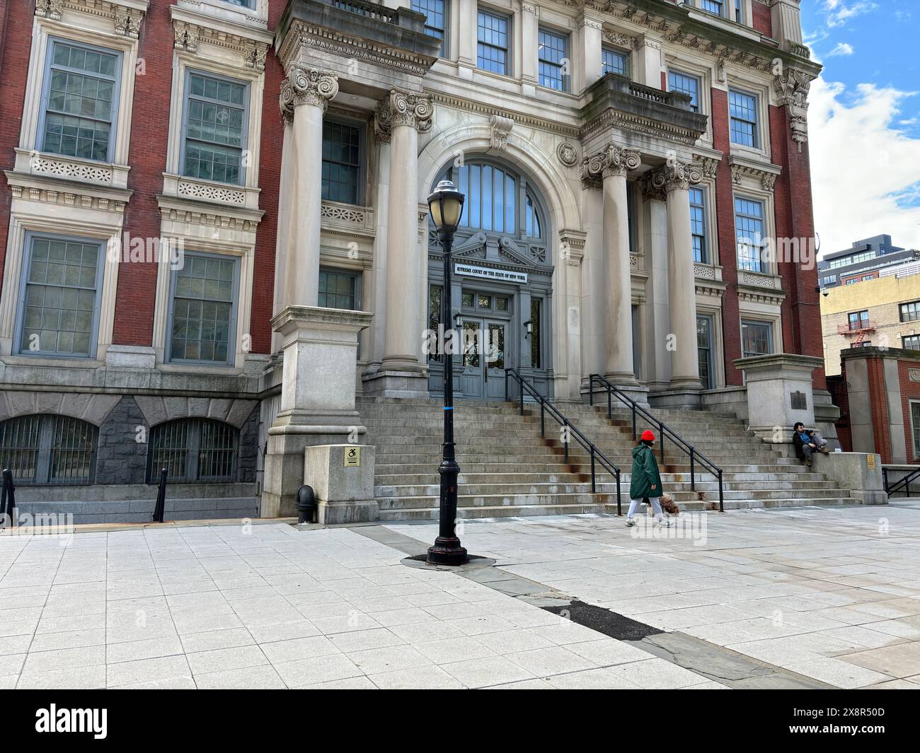 Historic courthouse with columns and people on steps in Queens, NY ...