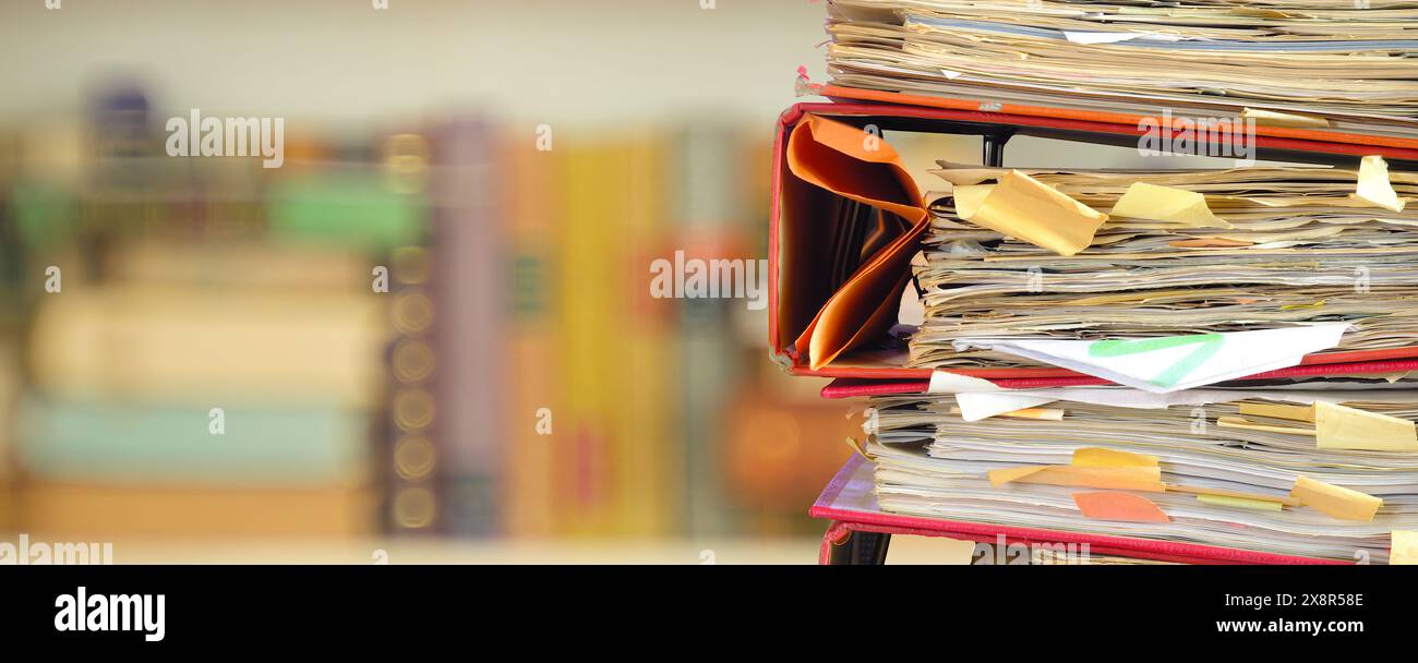stack of messy file folders with narrow depth of field, blurred ...