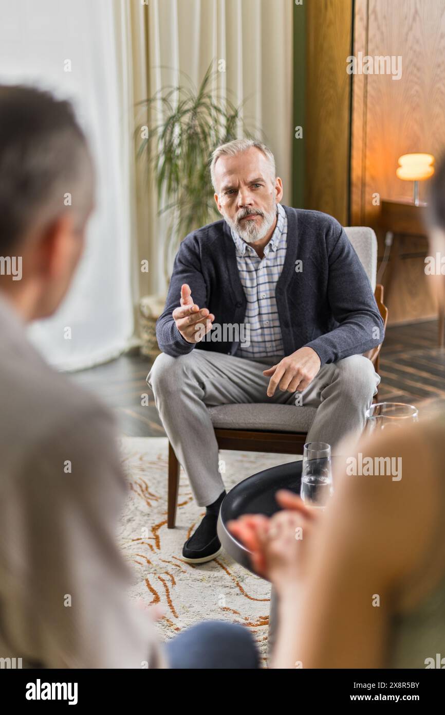 grey haired male psychologist with beard at family therapy Stock Photo ...