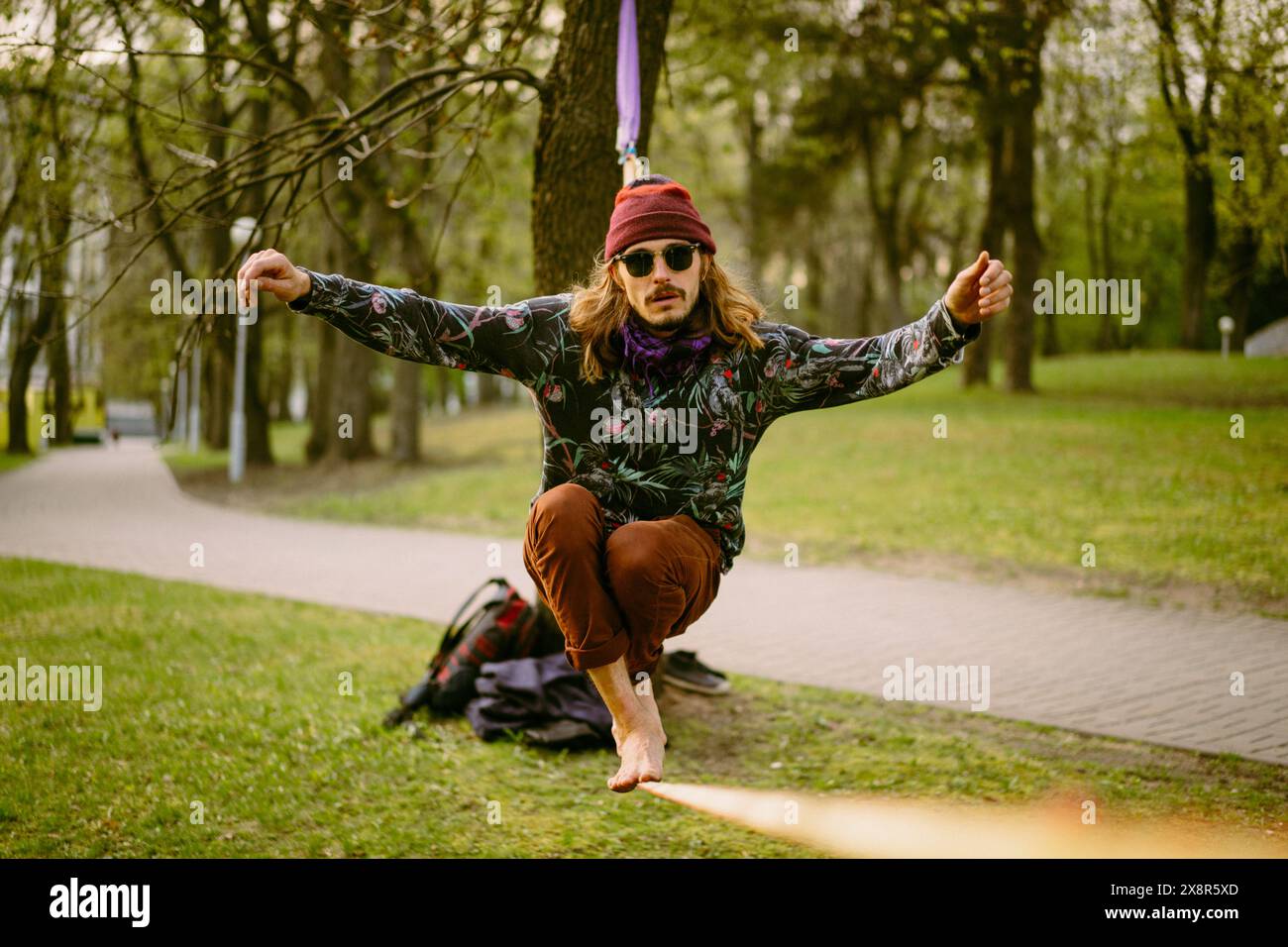Athletic man trains on a slackline Stock Photo - Alamy