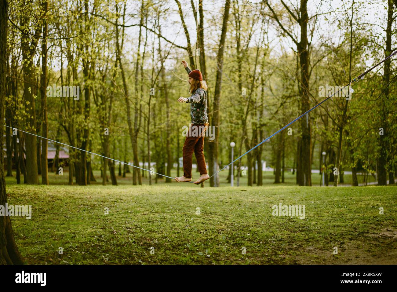 Athletic man trains on a slackline Stock Photo - Alamy